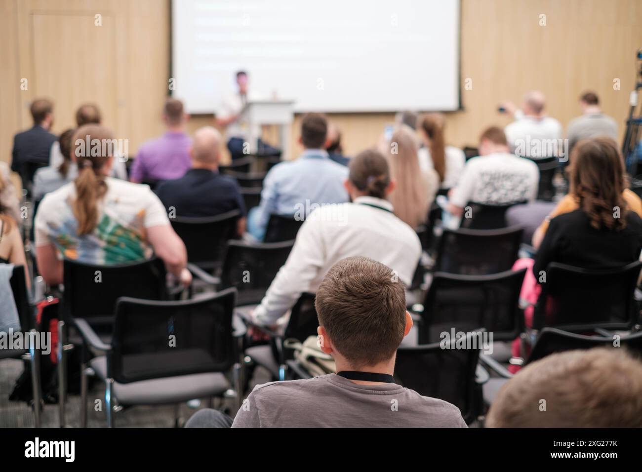 Attendees seated in a conference room listening to a speaker at a tech ...