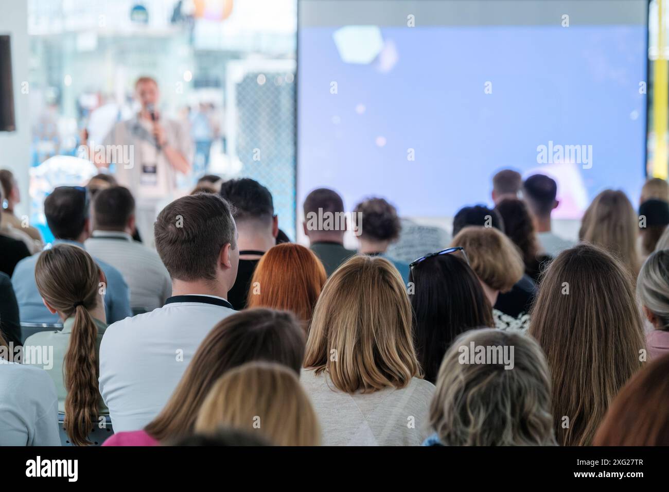 Large group of people attending a business conference, focusing on a ...