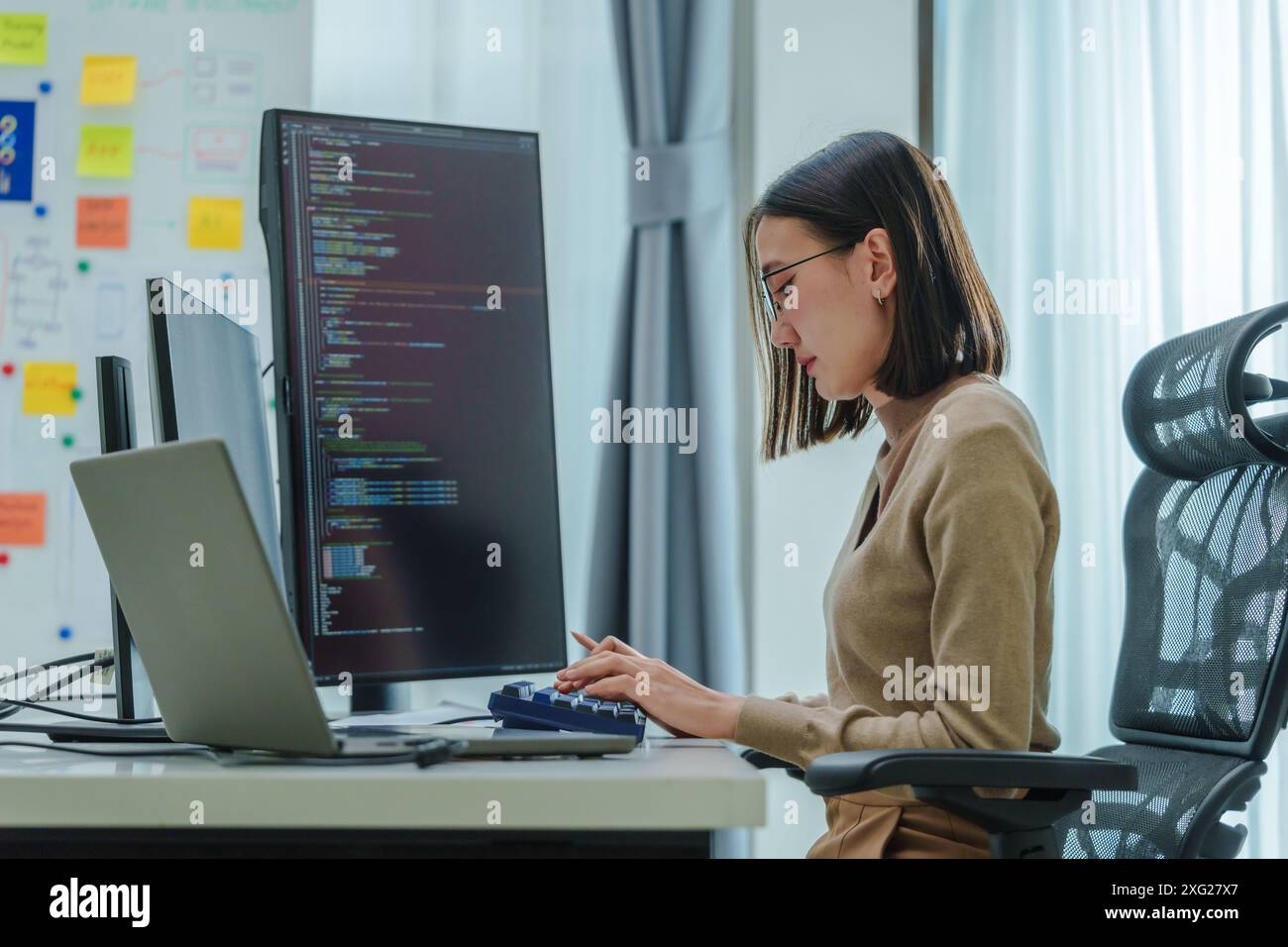 Asian Prompt Engineer Develop Coding App With Software Data Sitting In