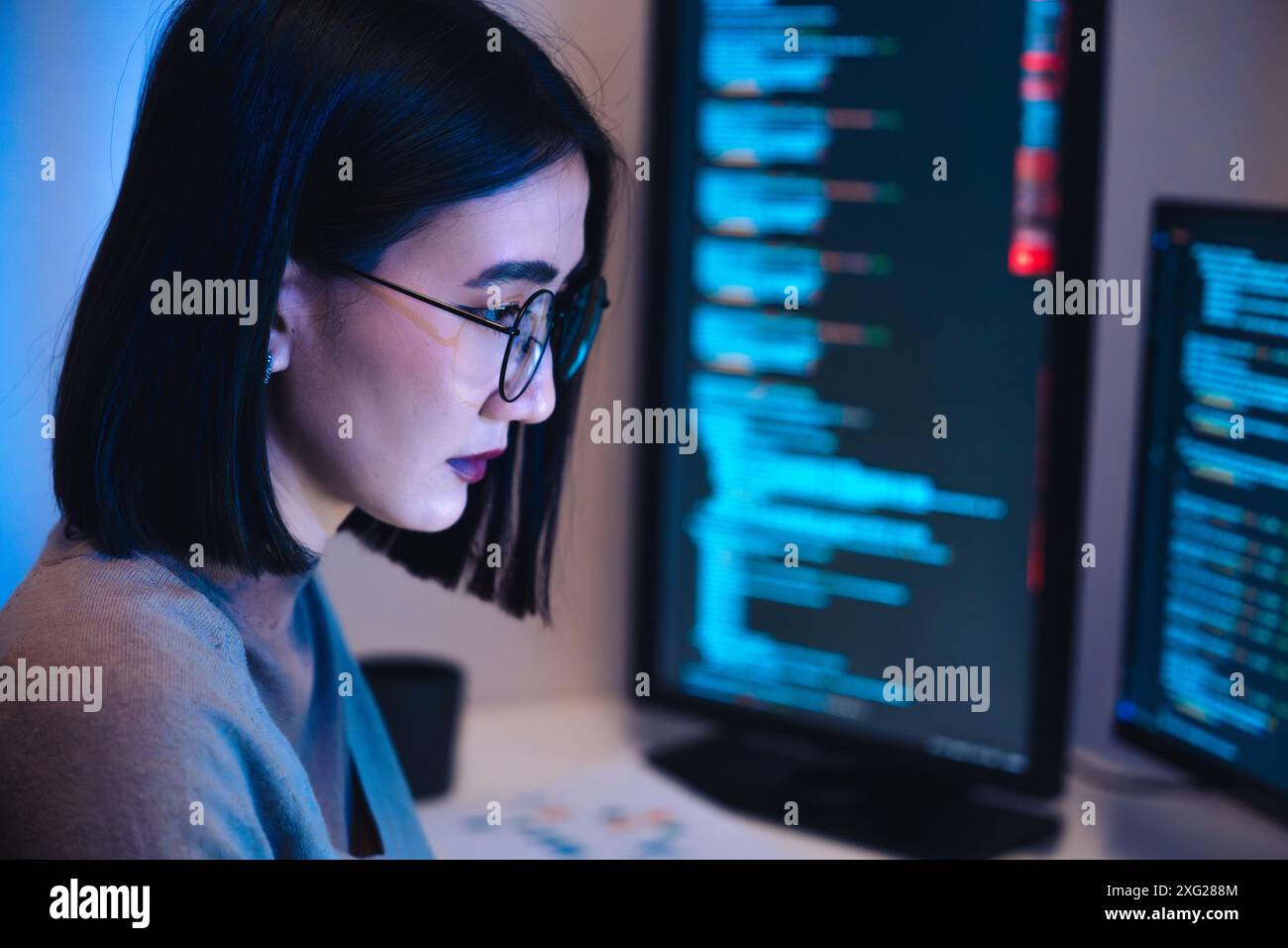 Asian woman software development working on coding computer screen and ...