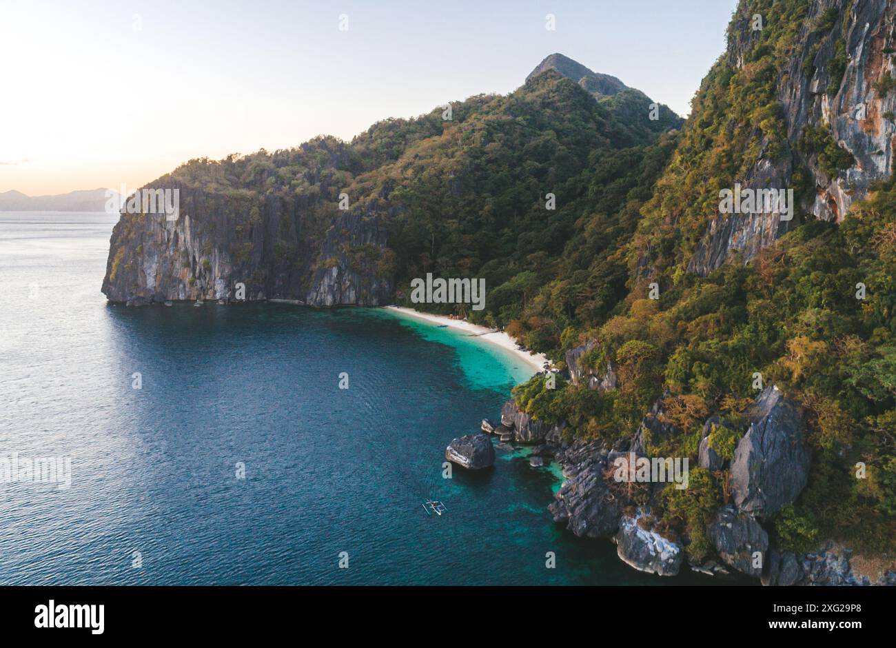 Aerial view of a secluded beach on a lush island in the Philippines ...