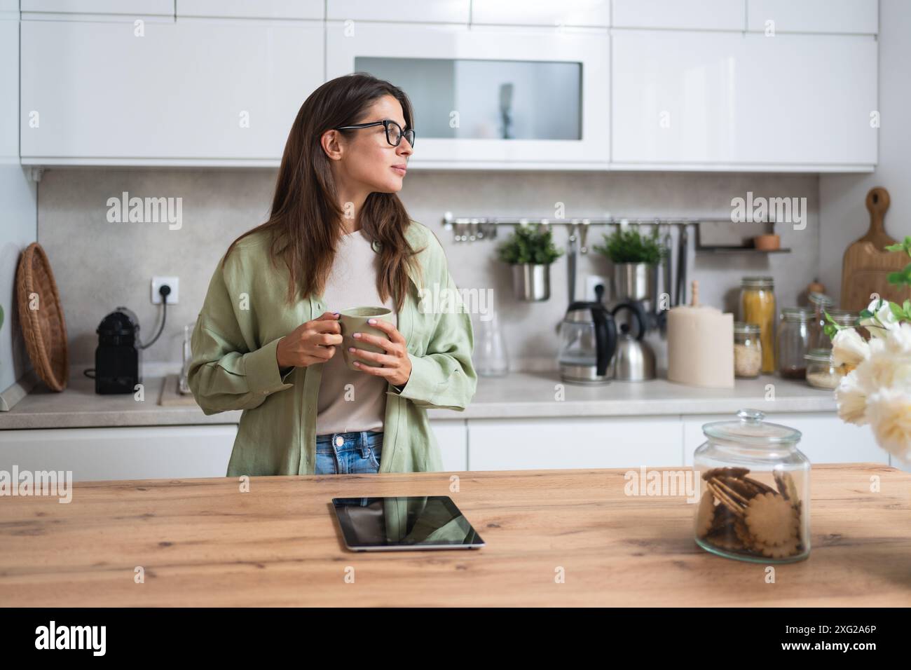 Simple living. Young woman morning routine in domestic kitchen in her ...