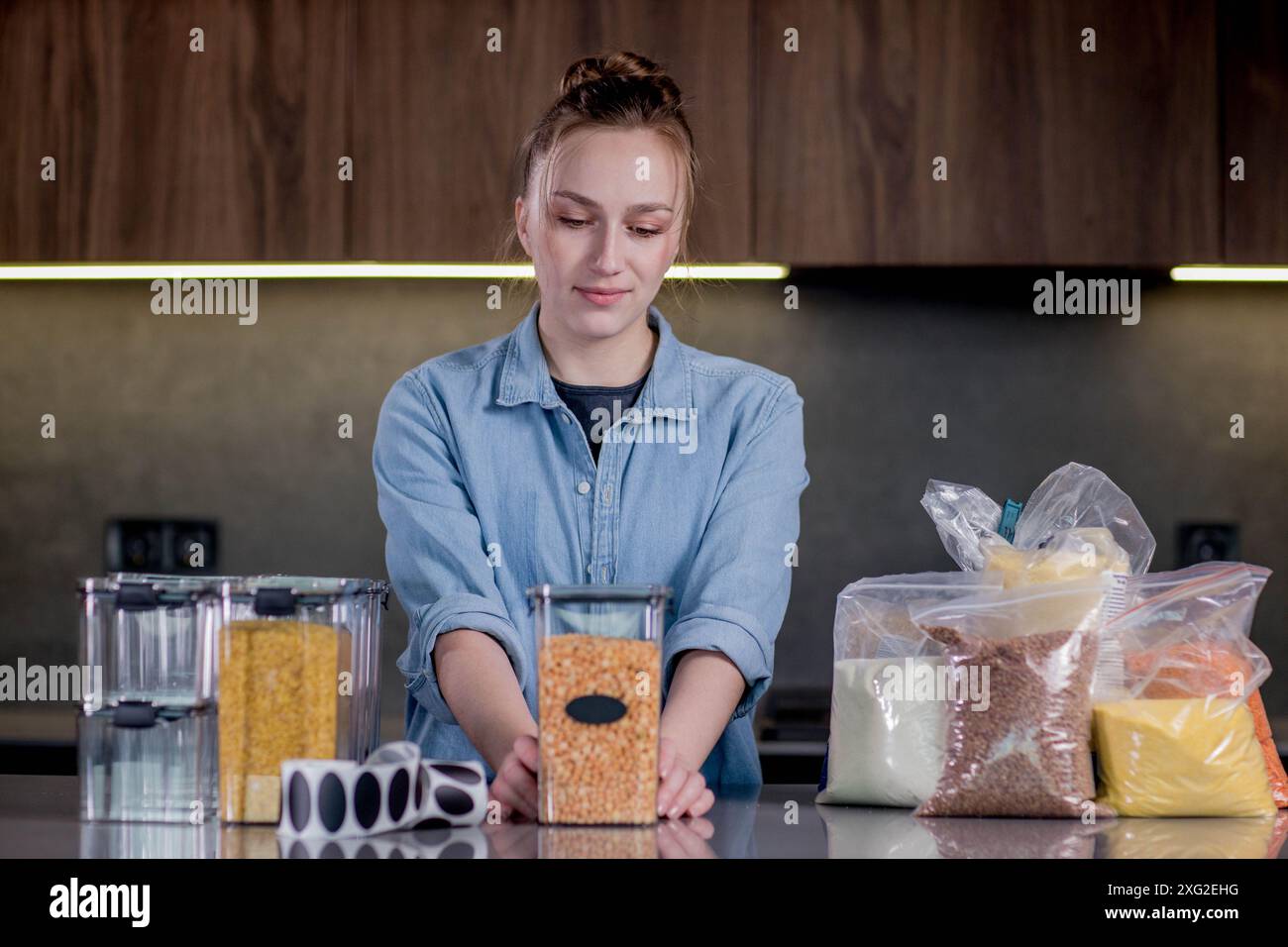 Nice woman organizes the placement of food in plastic cans. Woman signs ...