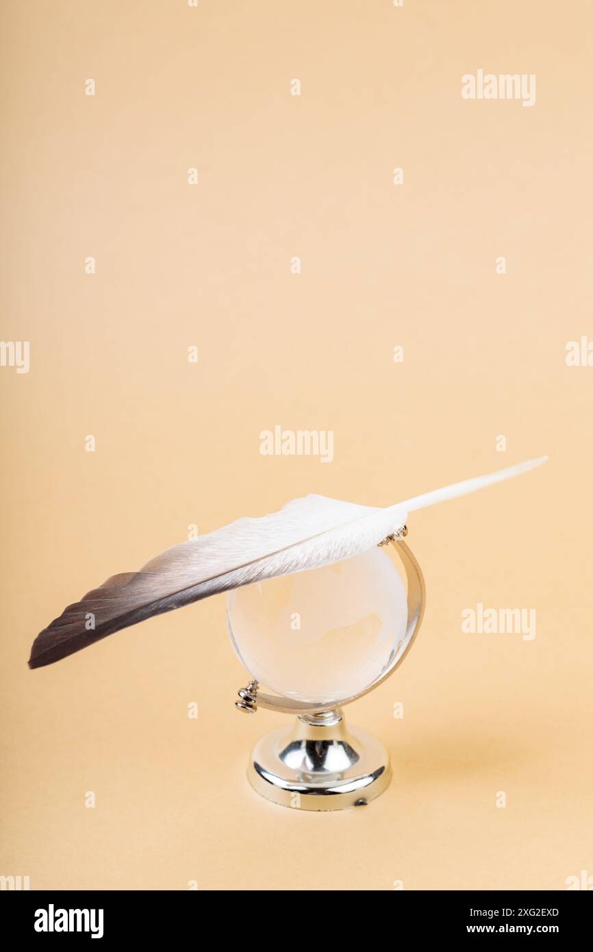 Glass Globe with Balancing Bird Feather, Fragile Balance of Earth's ...