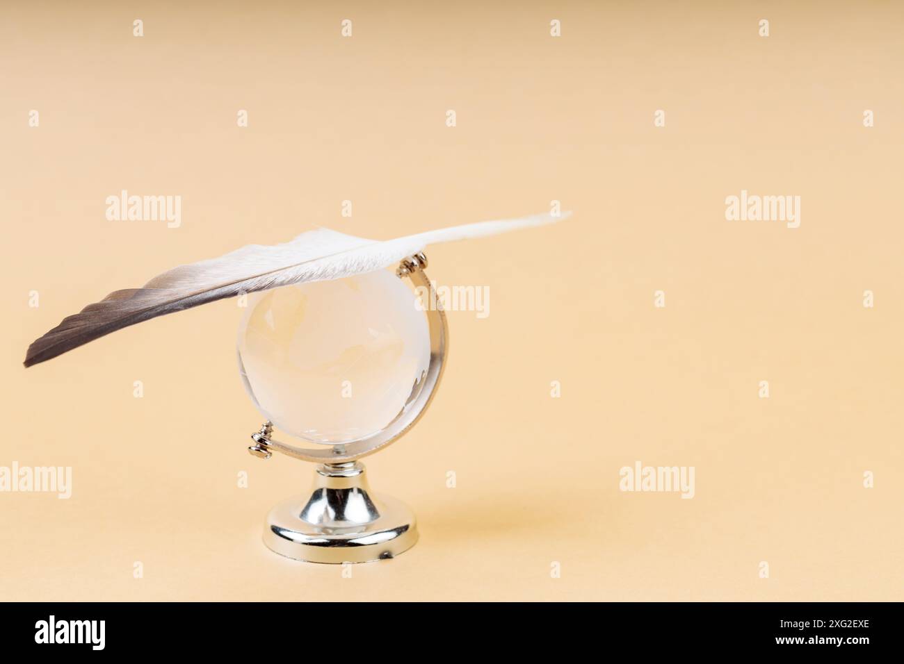 Glass Globe with Balancing Bird Feather, Fragile Balance of Earth's ...