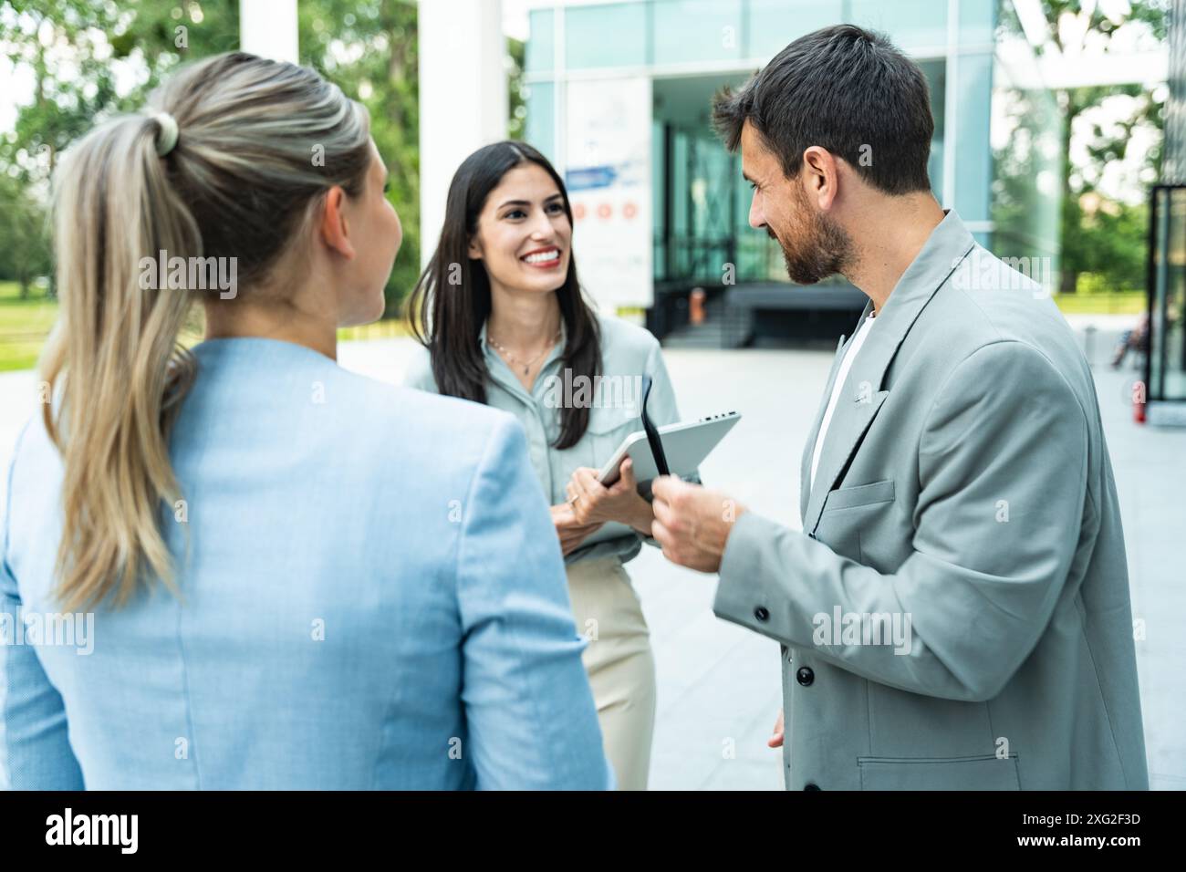 Team of business people talking in front of office building. Staff ...