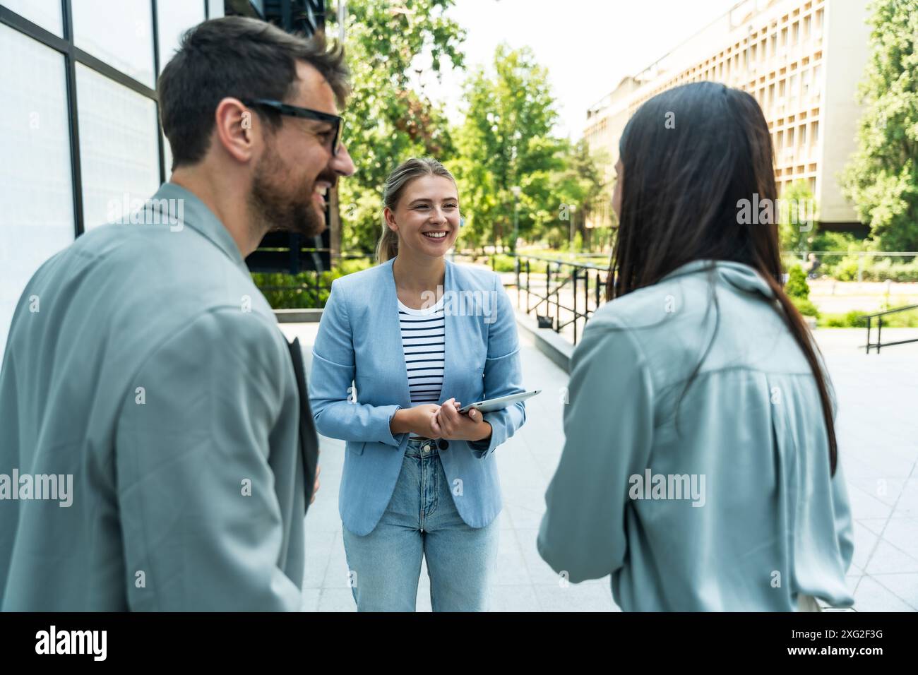 Team of business people talking in front of office building. Staff ...