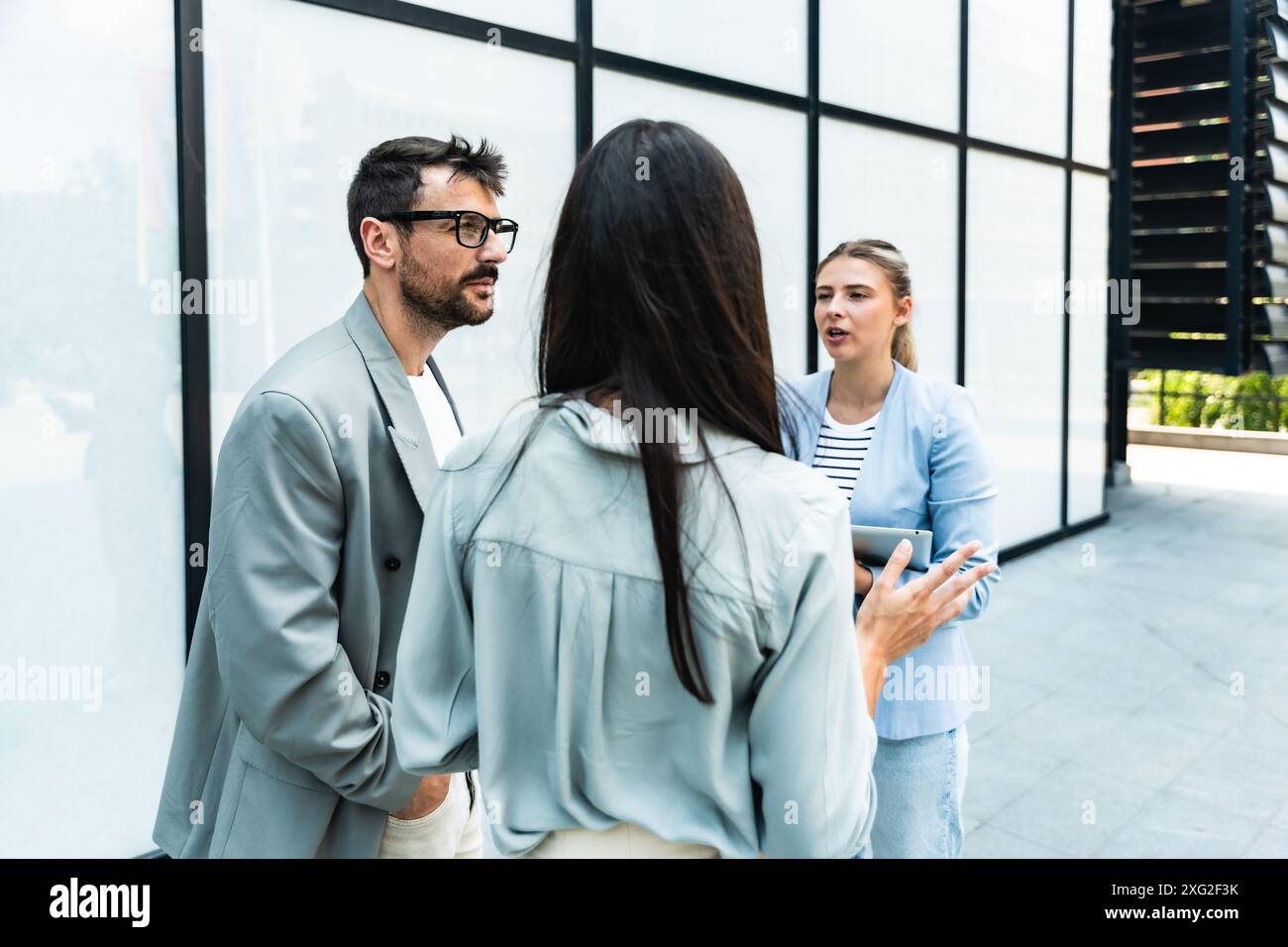Team of business people talking in front of office building. Staff ...