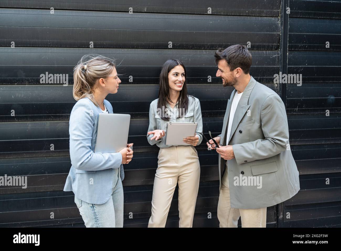 Team of business people talking in front of office building. Staff ...