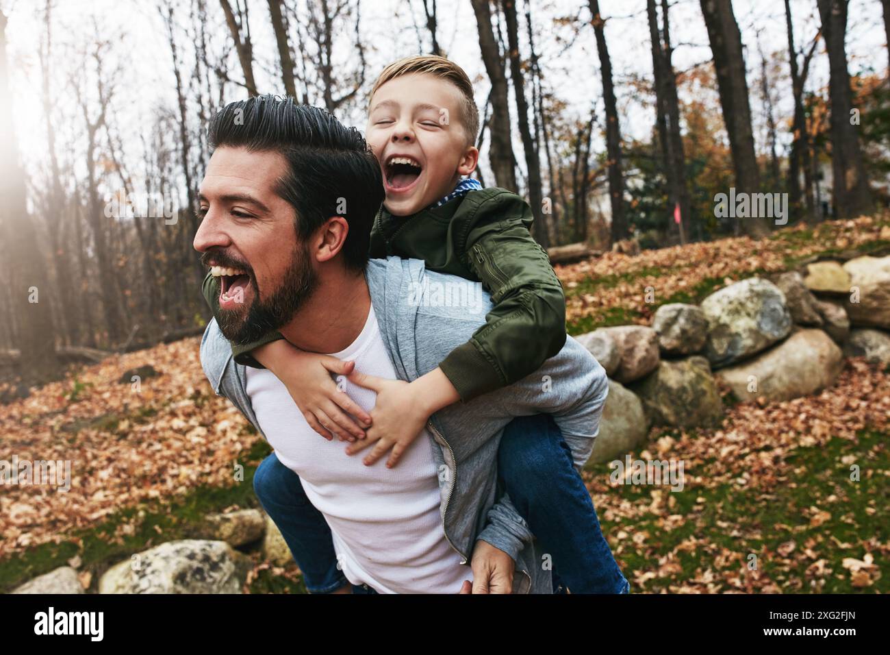 Nature, piggyback and dad with boy in forest for game, fun and bonding ...
