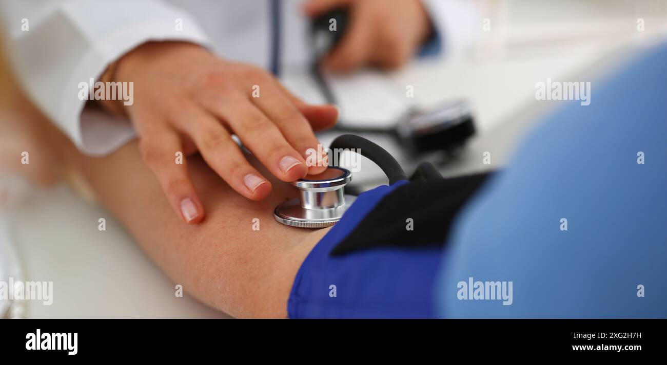 Nurse measure blood pressure with tonometer tool in clinic Stock Photo ...