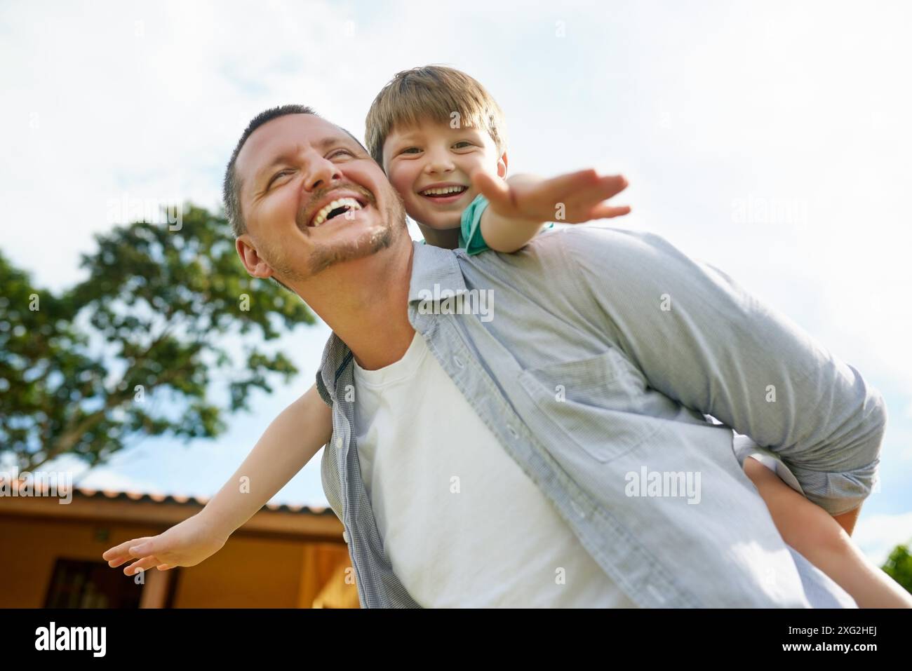 Father, kid and piggyback in backyard for fun, love and bonding to ...