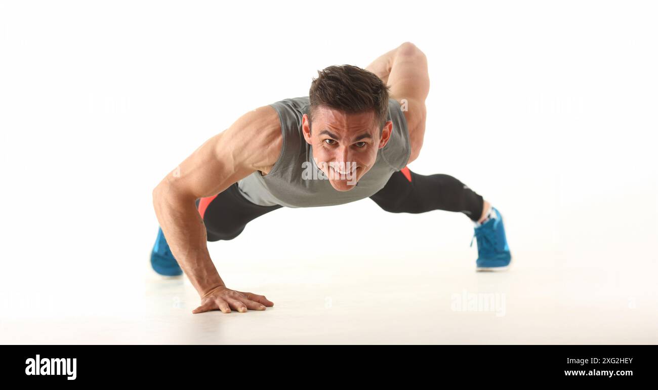 Strong man perform biceps and triceps workout at home without equipment ...