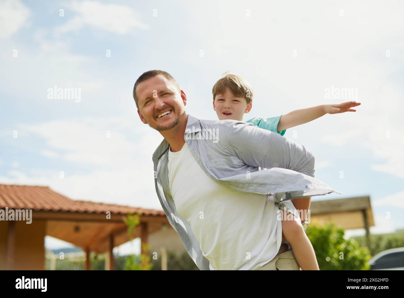 Father, boy and piggyback portrait in backyard, love and bonding to ...
