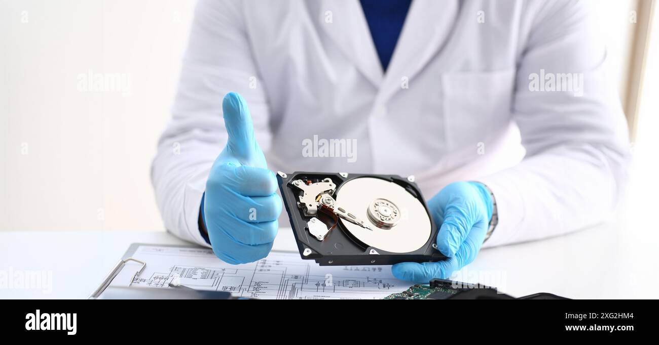 Man in uniform hold disassembled hard drive from computer, hdd and ...