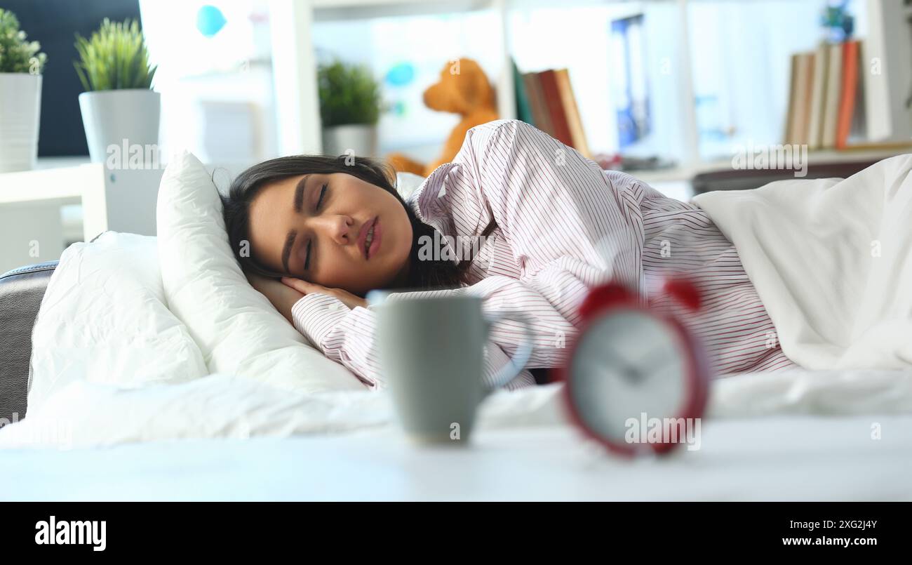 Young woman peacefully sleeping in bed, tired female, tough night ...