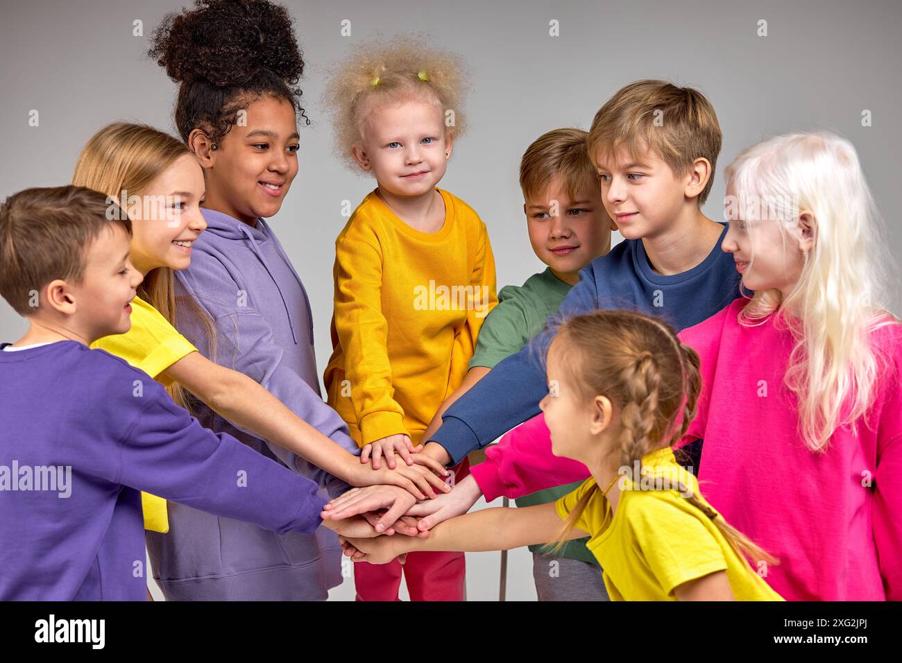 Team wok And Children Concept. Diverse happy group of kids putting ...