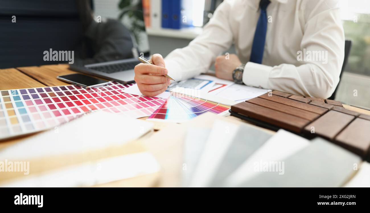 Interior designer man work on new project, palette on workplace Stock ...