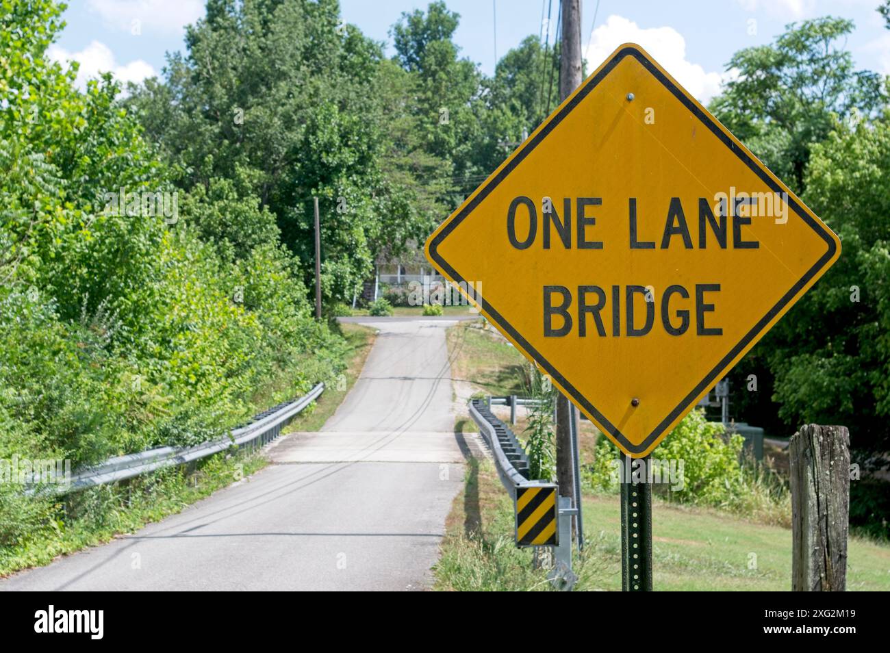 One Lane Bridge sign along a country lane with guardrails Stock Photo ...