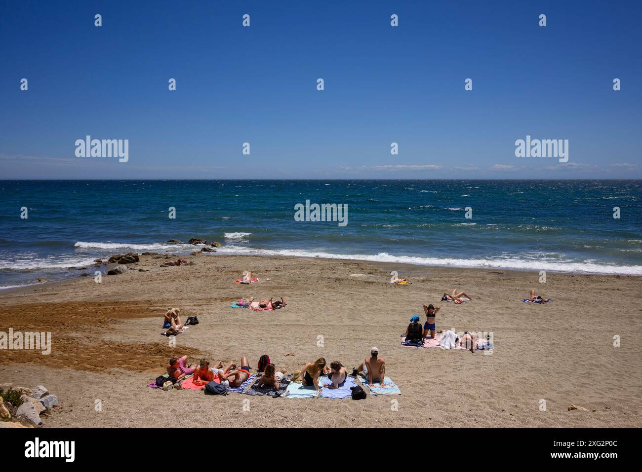 People sunbathing on the beach, Marbella, Spain Stock Photo - Alamy