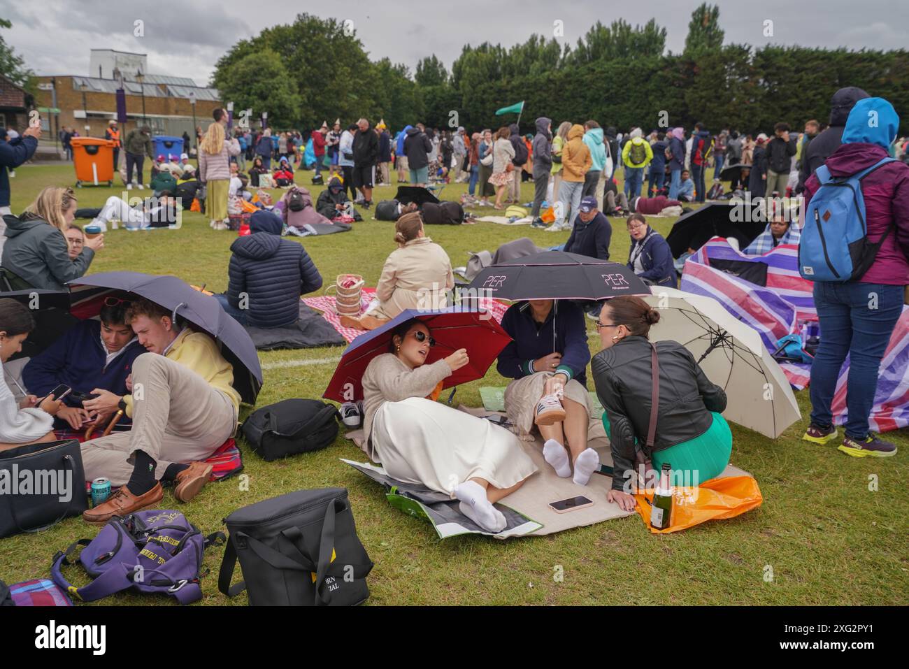 Wimbledon, London UK 6 July 2024. Tennis fans queuing with umbrellas ...