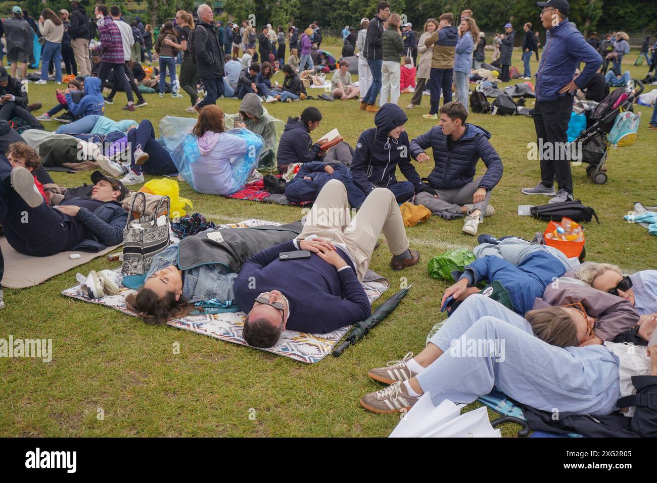 Wimbledon, London UK 6 July 2024. Tennis fans queuing with umbrellas ...