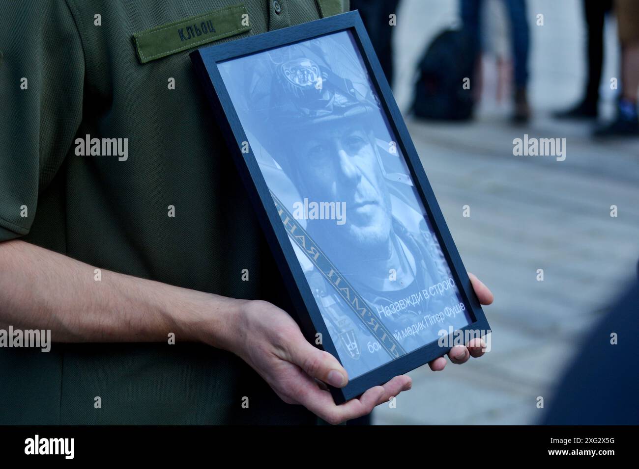A guard of honor holds a portrait of a British citizen, Peter Fouche ...