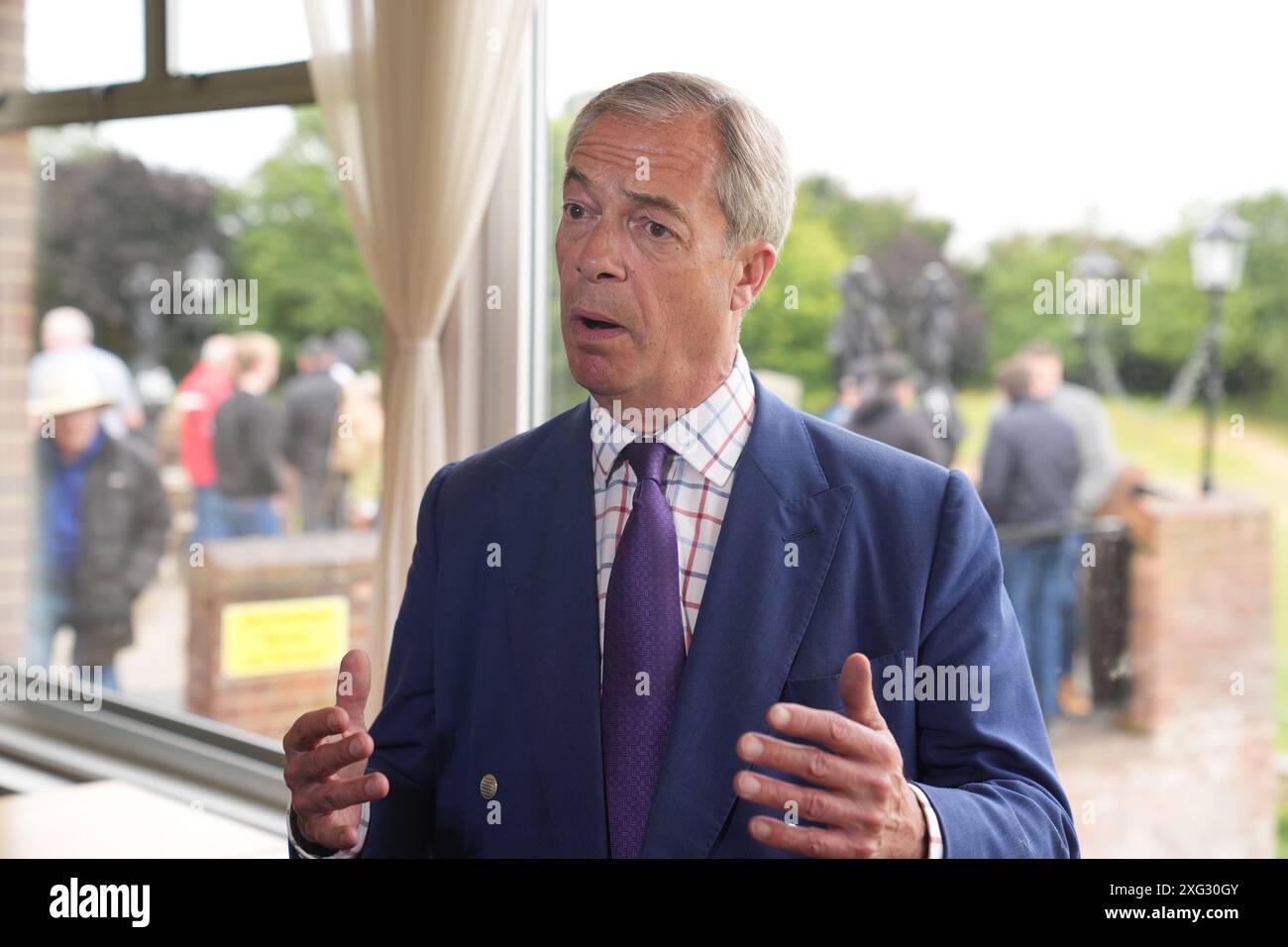 Reform UK leader Nigel Farage speaks to the media during a visit to ...