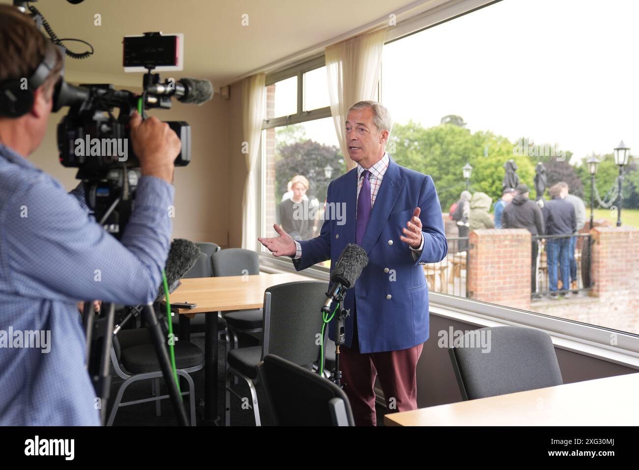 Reform UK leader Nigel Farage speaks to the media during a visit to ...