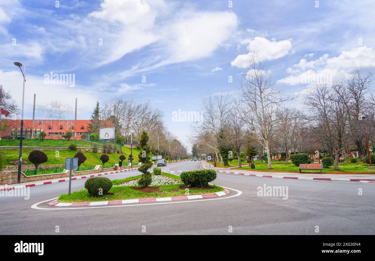 Charming cityscape of Ifrane with red roofs, green lawns, and vibrant ...
