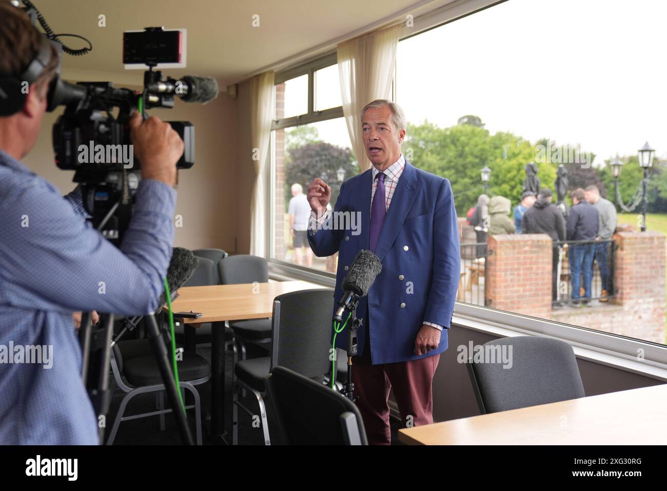 Reform UK leader Nigel Farage speaks to the media during a visit to ...