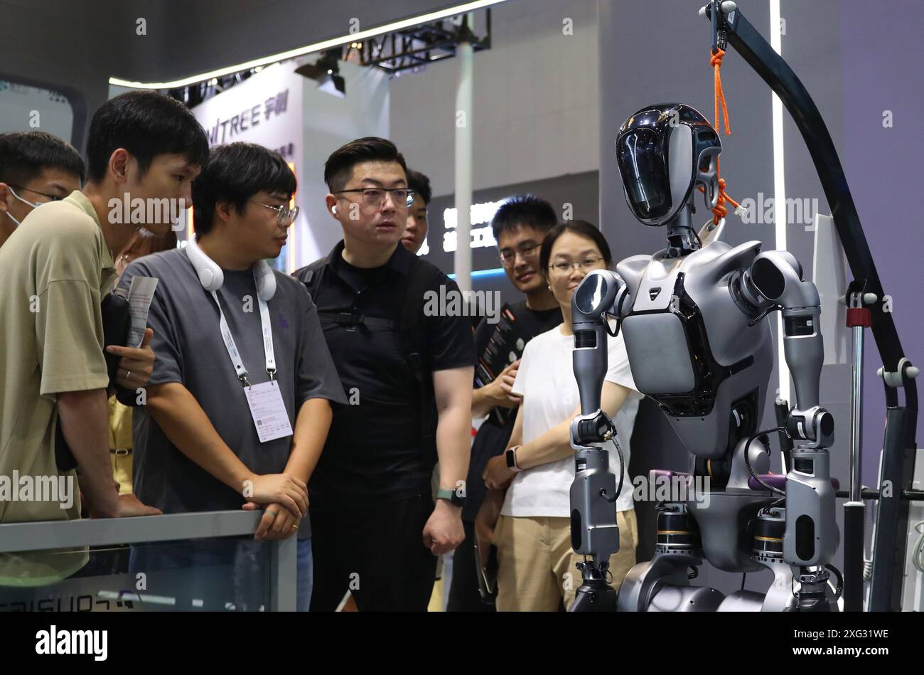 Shanghai, China. 5th July, 2024. Visitors look at a robot during the ...