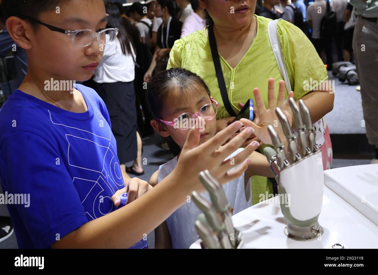Shanghai, China. 5th July, 2024. Children look at mechanical hands ...