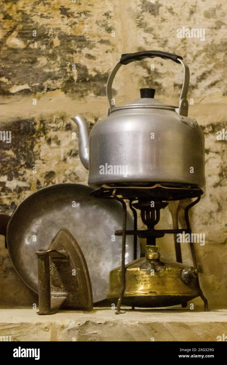 an old metal kettle on the stove in the kitchen Stock Photo - Alamy