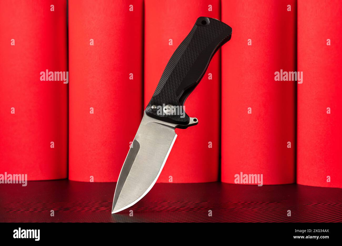Folding knife on a red background. Pocket knife. EDC knife Stock Photo ...