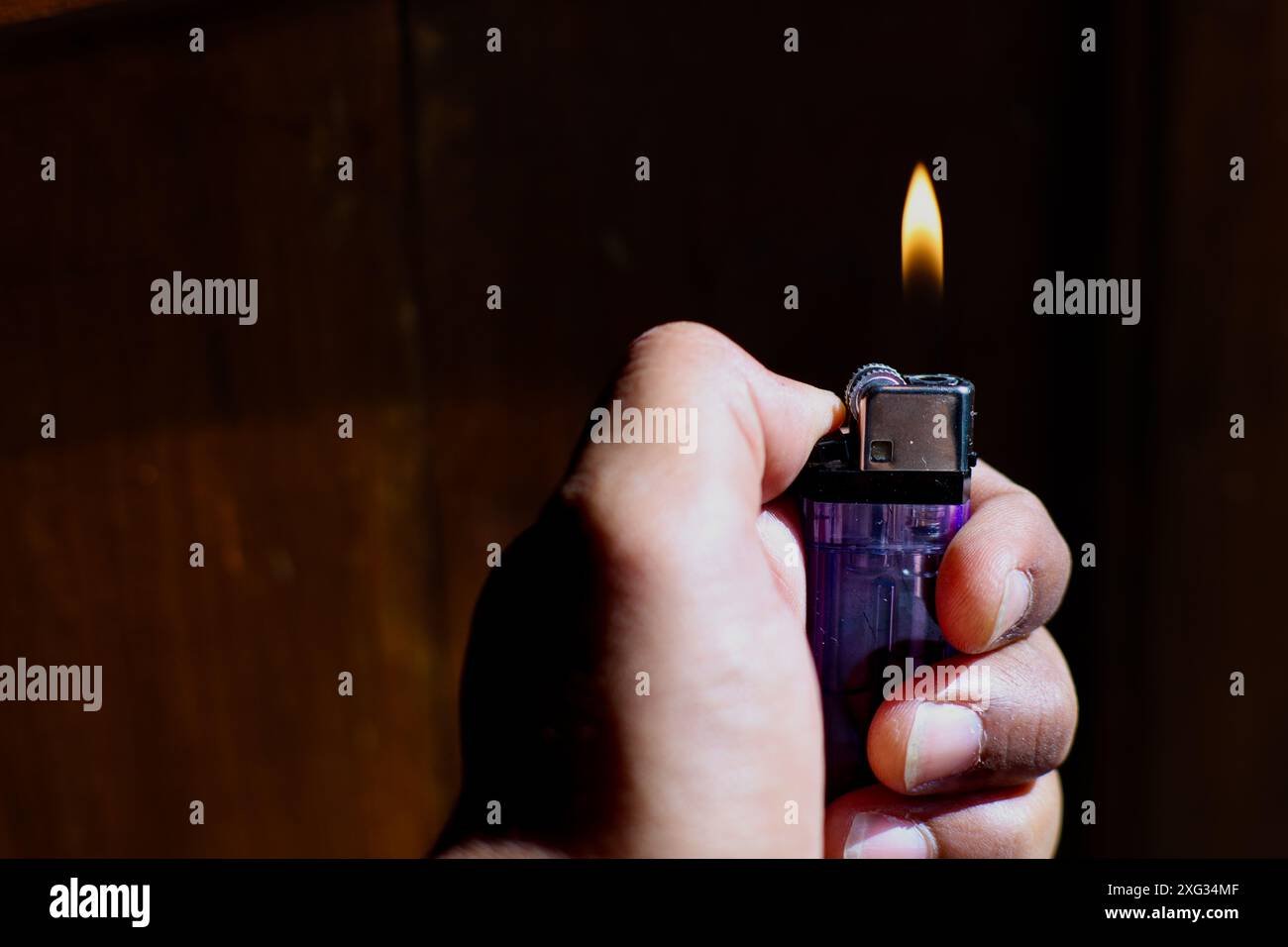 Hand holding a lit match Stock Photo - Alamy