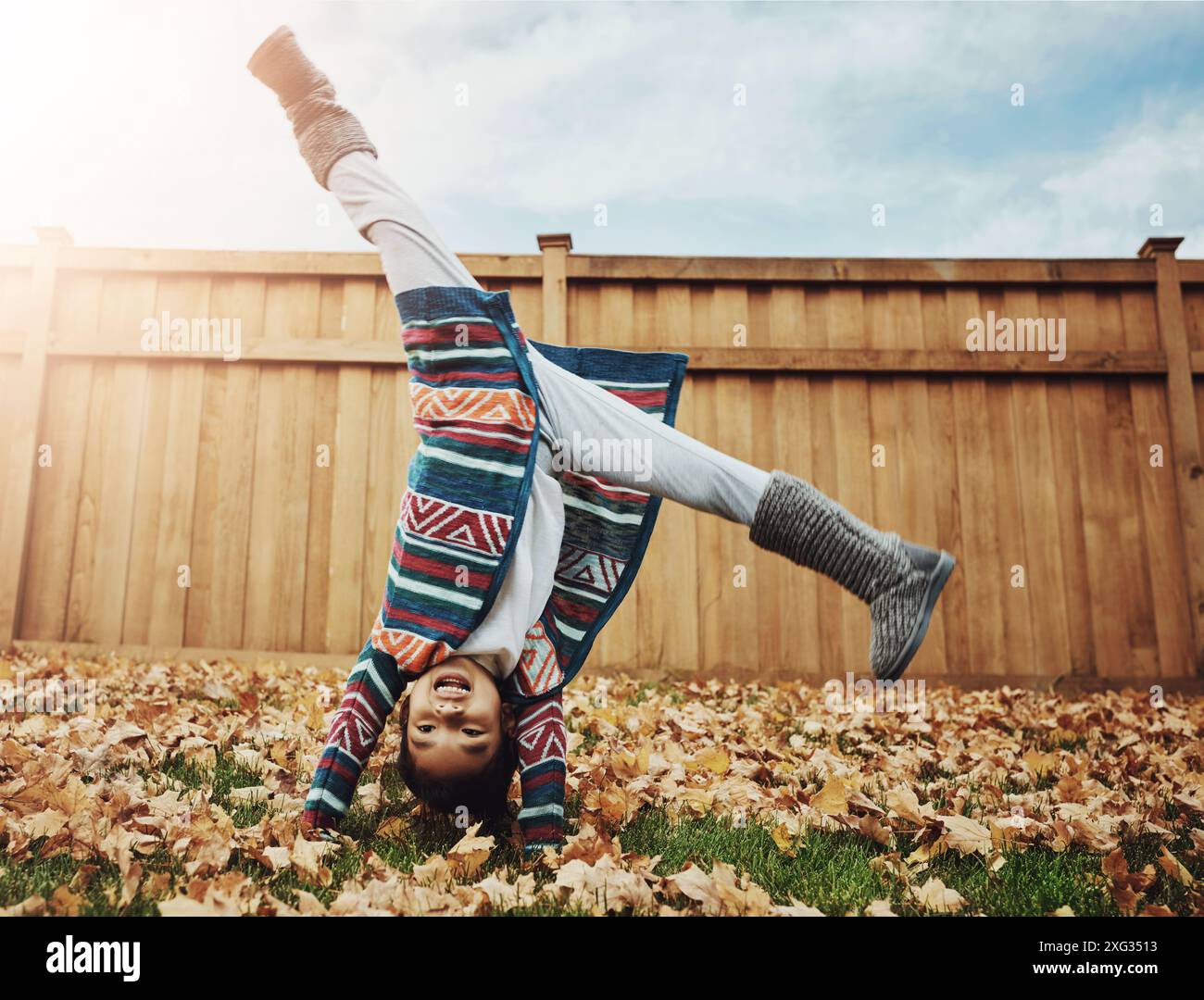 Girl, child and playing cartwheel outdoor in backyard for autumn fun ...