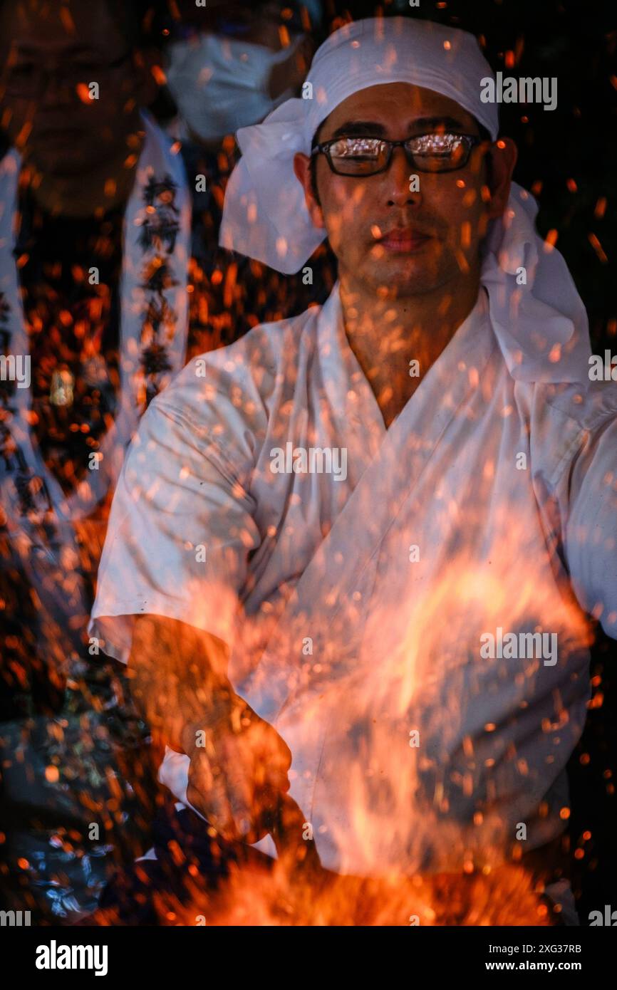 JULY 6, 2024 - A swordsmith, or katana kaji, forges steel in a public ...