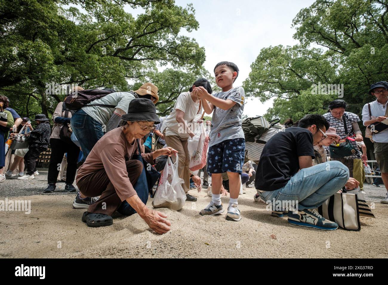 JULY 6, 2024 - People collect sand from a ceremonial dohy following a ...