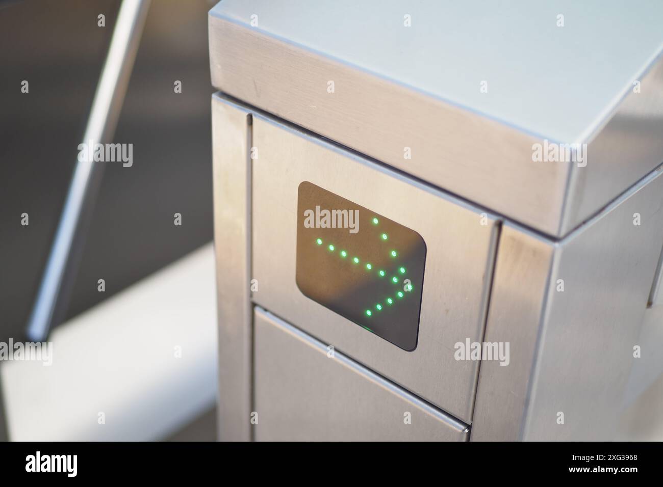 Modern turnstile gate with green arrow indicator for direction control ...