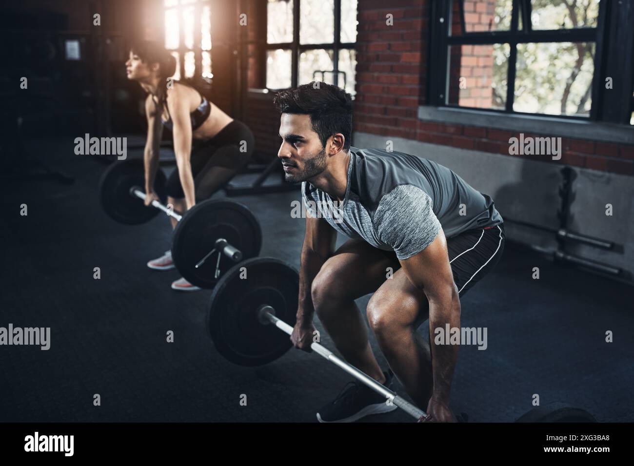 Deadlift, couple and workout with barbell in gym for muscle, wellness ...