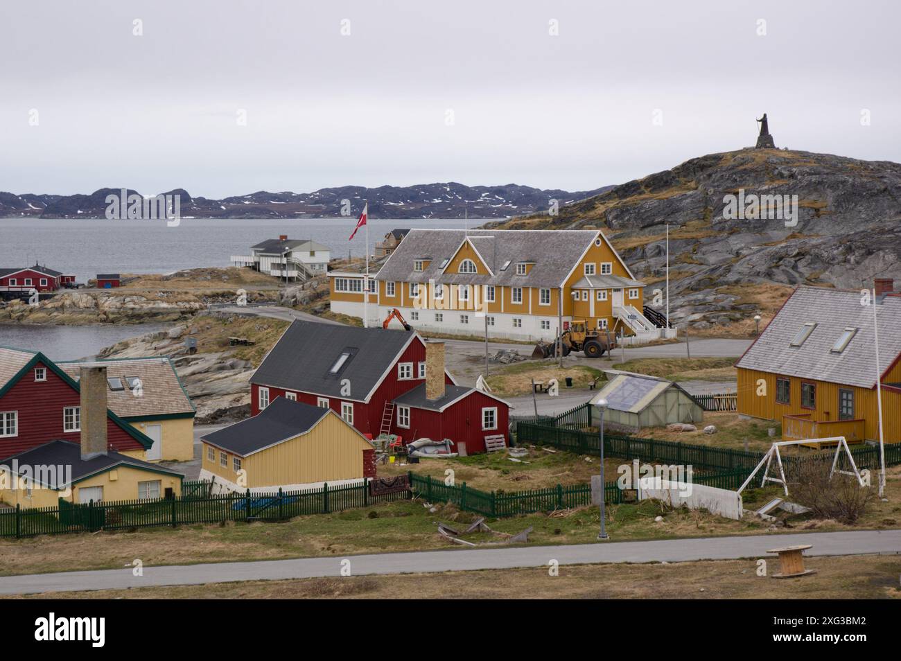 Statue of Hans Egede looks over the timber buildings of Old Nuuk ...