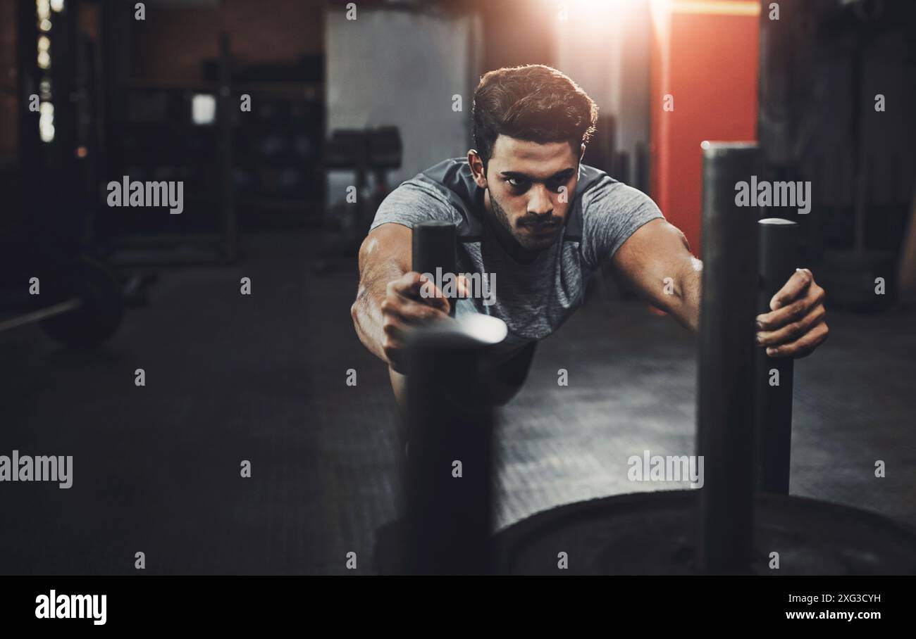 Man, sled and push in gym for fitness or muscle endurance, leg strength ...