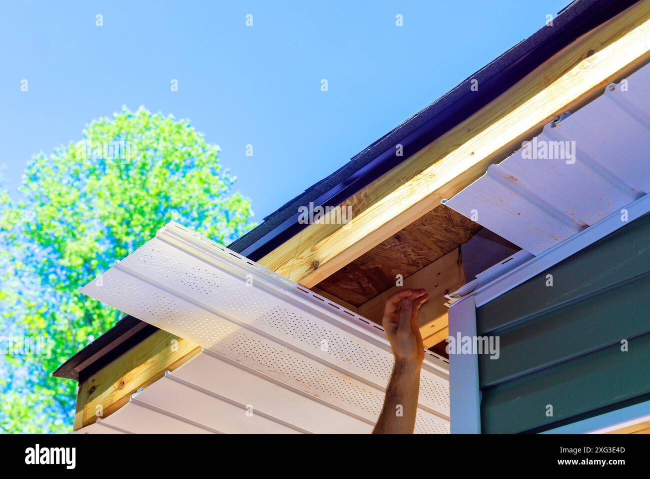 In new house, employee installed vinyl soffit plastic panels on facade ...