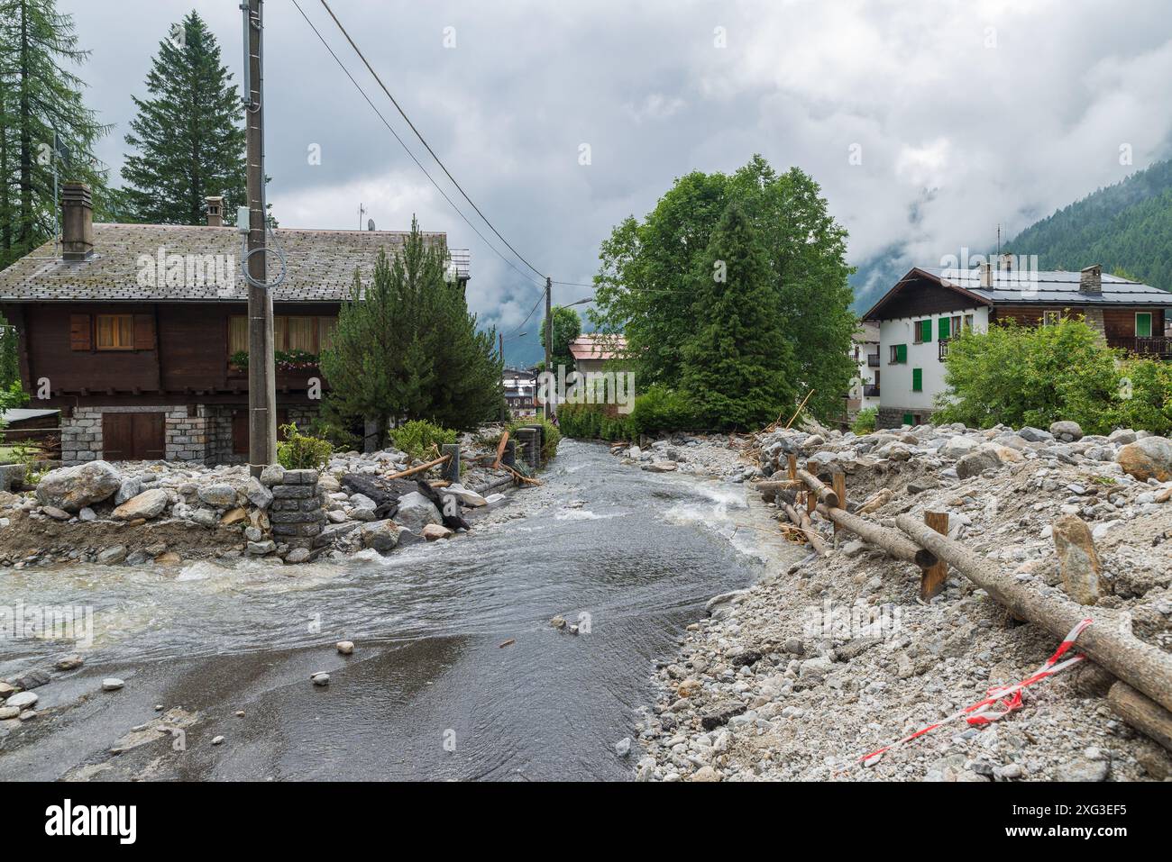 Overflowing of a torrent, flooding and landslides among the houses of a ...