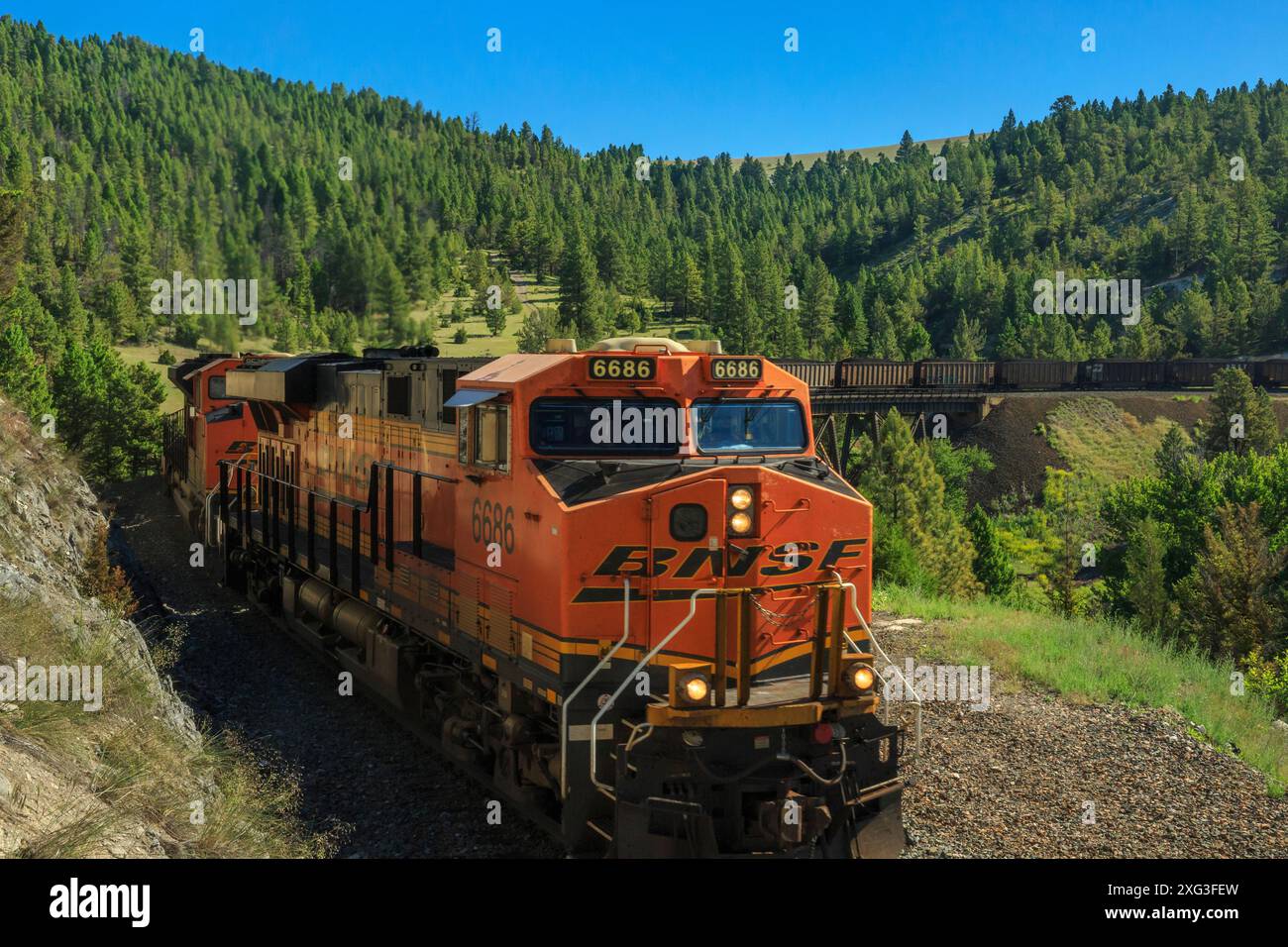 coal train heading to mullan pass on the continental divide over a trestle near austin, montana ...