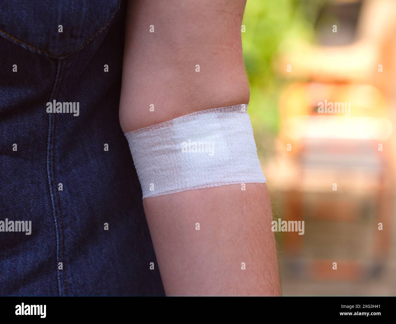 A bandage on the arm of a woman after having blood taken Stock Photo ...