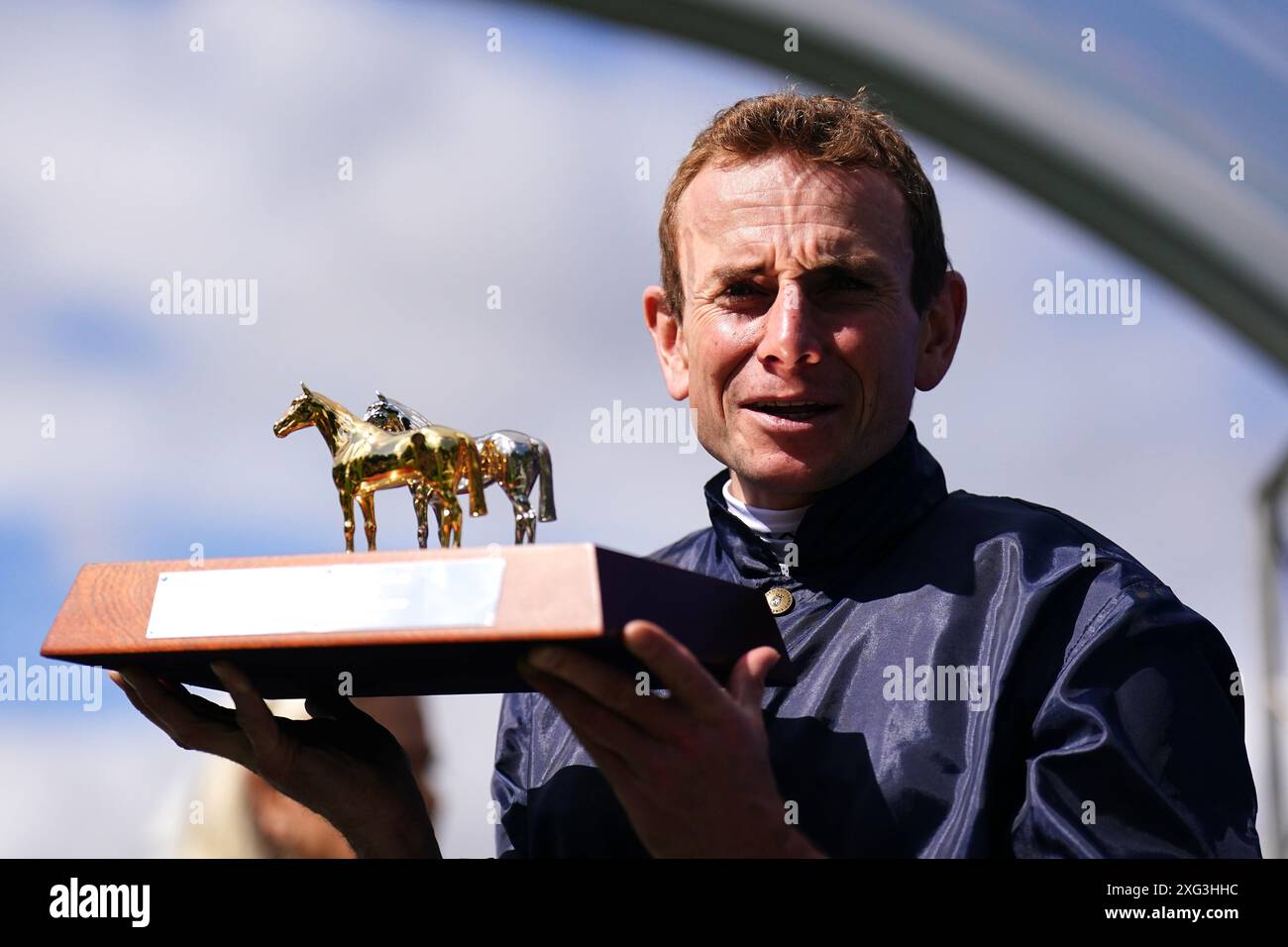 Jockey Ryan Moore celebrates with the trophy after winning the Coral ...