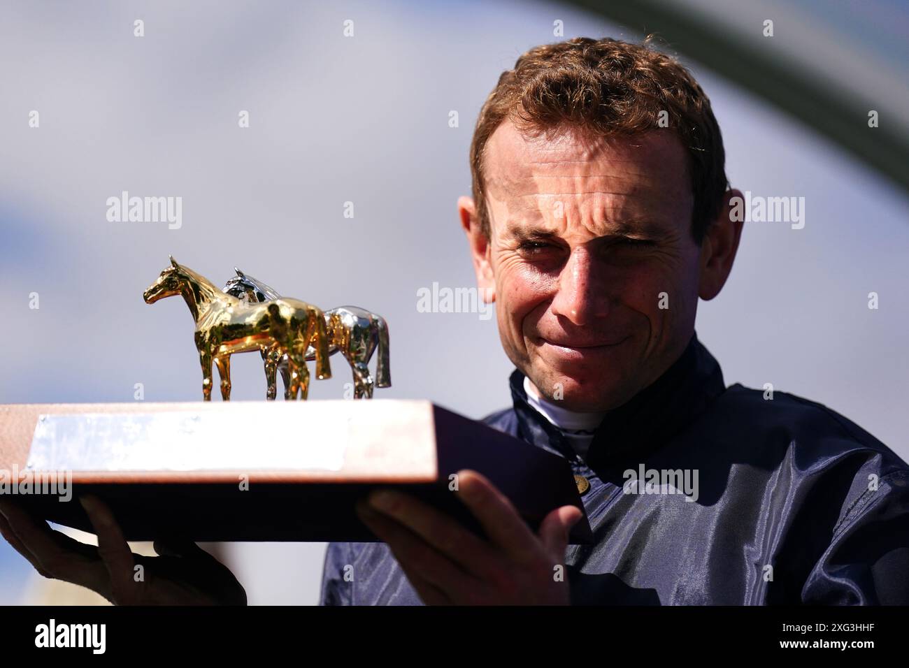 Jockey Ryan Moore celebrates with the trophy after winning the Coral ...