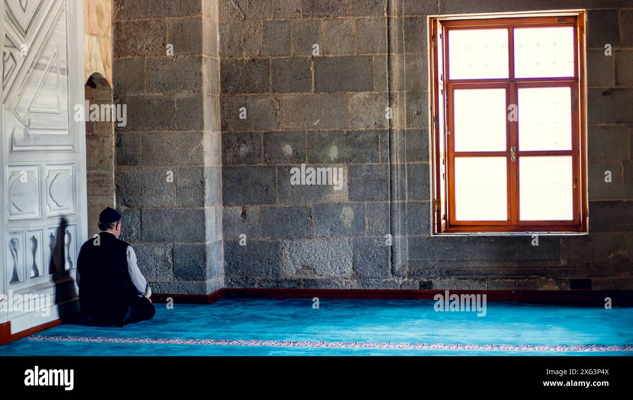 Islamic themed background photo. Man praying in a mosque, symbolizing ...